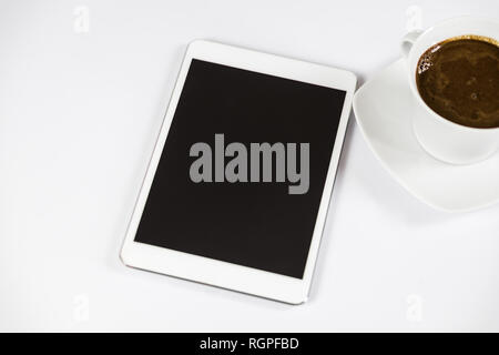 Business workplace with tablet device coffee cup and media interface ...