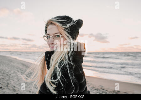 Klaipeda, Lithuania: A young cheerful woman holds a chess piece in her ...