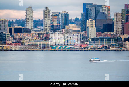 A boat cruises across Elliott Bay in front of the Seattle skyline Stock ...
