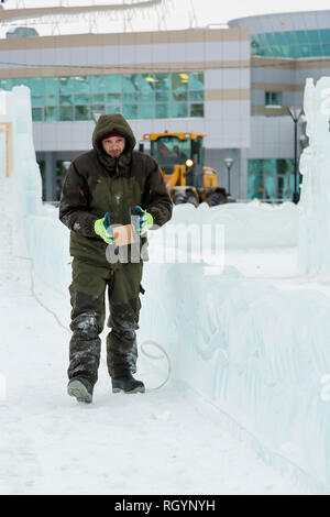 Electrician mounts power cable to illuminate ice figures Stock Photo ...