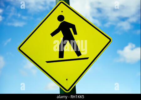 Yellow pedestrian road safety walkway sign painted a road in a car ...