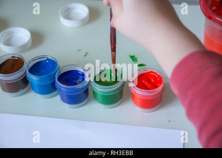 Gouache and water for painting and two kids drawing on background Stock ...