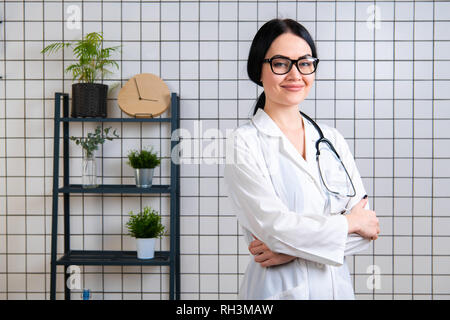 Beautiful smiling doctor standing in her modern office Stock Photo - Alamy