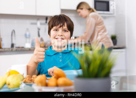 Portrait of tweenage boy having breakfast at kitchen at home Stock ...