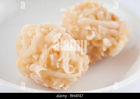 Colombian traditional coconut sweet called cocada in a white ceramic ...