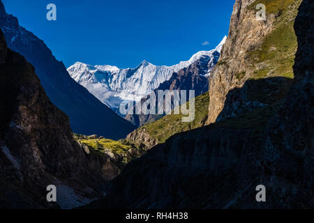 Panoramic view down snow covered valley in alpine mountain range on ...
