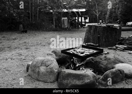 An australian style bush bbq with food cooking over a campfire, Finch ...