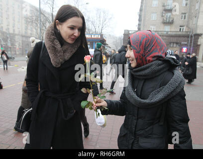 Ukrainian muslim women present flowers to women during their a ...