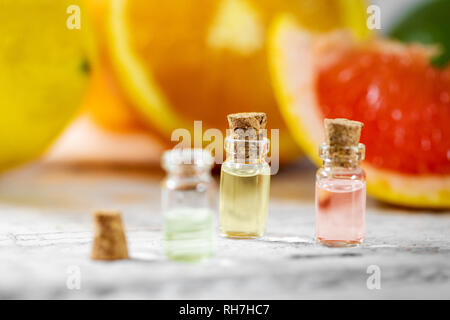 Bottles of citrus essential oil on red background Stock Photo - Alamy