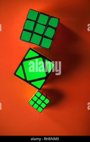 collected different conundrum on red background Stock Photo - Alamy