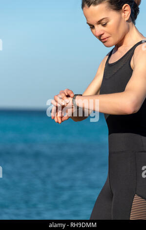 Woman runner with a stopwatch Stock Photo - Alamy