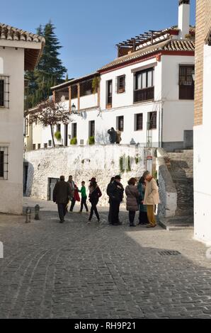 Granada, Spain - December 27, 2014: People strolling by typical street ...