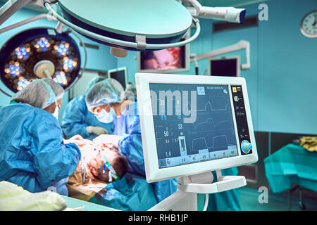 Monitoring patient's vital sign in operating room. doctor cheking at ...