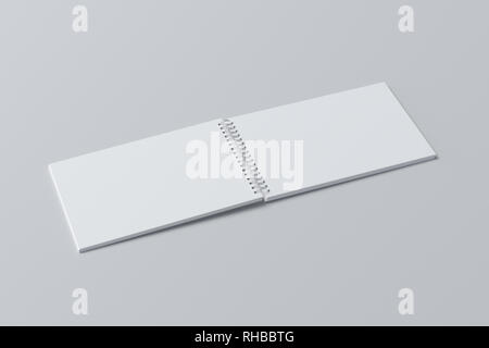 Blank open horizontal spiral notepad on black background. With clipping ...