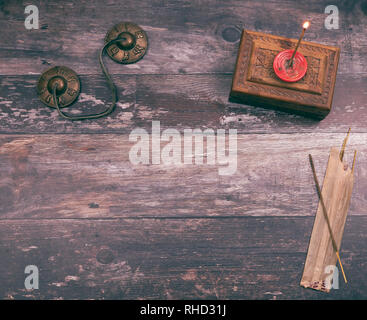 Burning incense stick on a wooden holder on a white background with ...