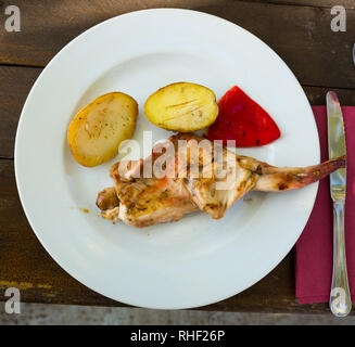 Grilled rabbit thigh with bell pepper and potatoes Stock Photo - Alamy