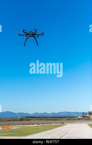 Professional drone flying over the airfield in hover Stock Photo - Alamy