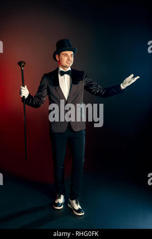 Professional showman wearing suit gloves and top hat standing isolated ...