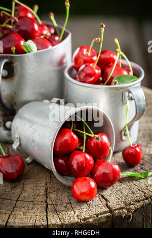 Fresh Cherries on an old wooden table as detailed close-up shot ...