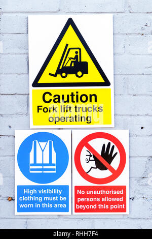Health and safety hazard warning signs on slatted wall shades of blue ...