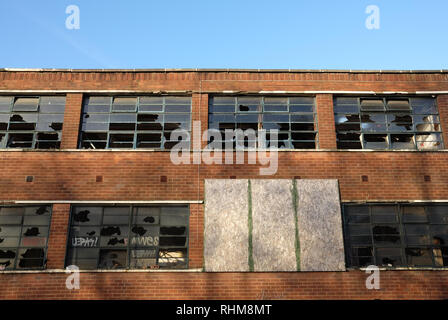 The broken windows of a derelict factory building Stock Photo - Alamy