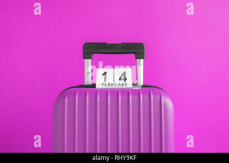 Suitcase with 14 of february wooden calendar and airplane model toy on ...