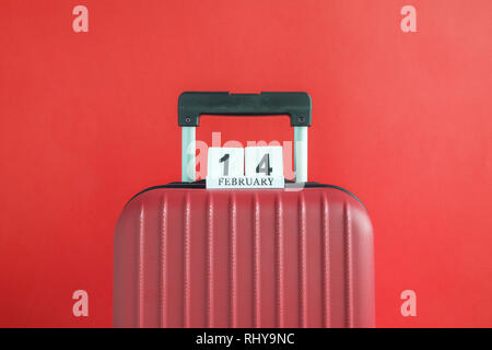 Suitcase with 14 of february wooden calendar and airplane model toy on ...