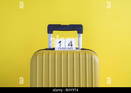 Suitcase with 14 of february wooden calendar and airplane model toy on ...