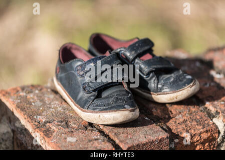 Worn out kids shoes Stock Photo - Alamy