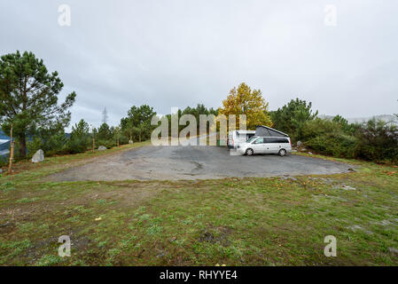 Campervan or motorhome camping on rainy day with rain puddles. Family ...