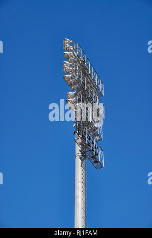 Tall sport stadium light stanchion or light tower from low angle in ...