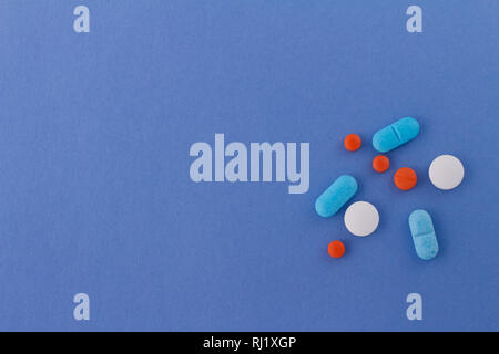 Pills of colors on neutral background of celestial color. Drugs for use ...