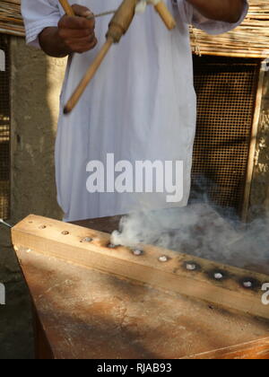 re-enacted scene of ancient Egyptian fire making, using a drill and ...