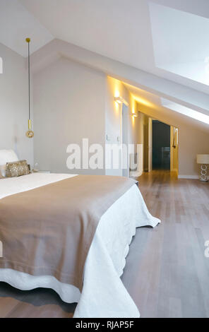 Interior of light bedroom with queen size bed and classic desktop ...