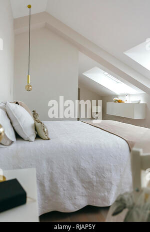 Interior of light bedroom with queen size bed and classic armchair ...
