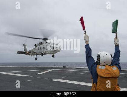 Flight deck crewmen aboard the destroyer USS JOHN HANCOCK (DD-981 ...
