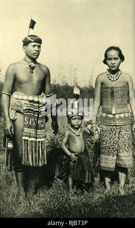 Iban woman and man in traditional tribal dress, Mengkak Longhouse ...