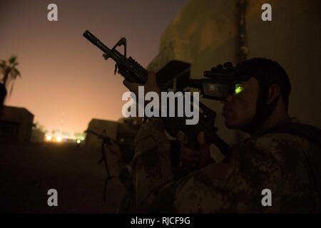 Elite military soldier with night vision device on helmet standing ...