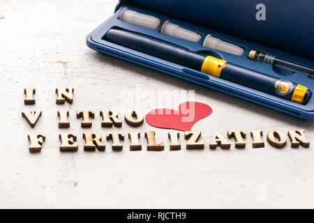 In Vitro Fertilization injection pen held in hand of white background ...