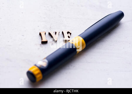 In Vitro Fertilization injection pen held in hand of white background ...