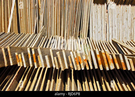 rough cut timber planks with bark edges piled in a stack Stock Photo ...