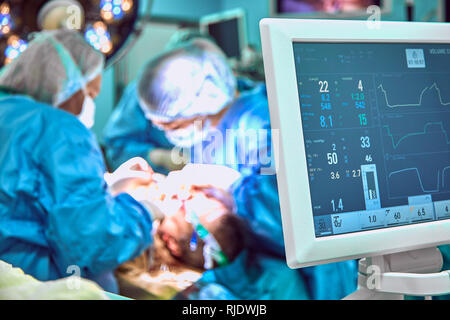 Monitoring patient's vital sign in operating room. doctor cheking at ...