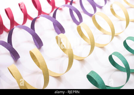 Mixed colorful streamers on a white background Stock Photo - Alamy