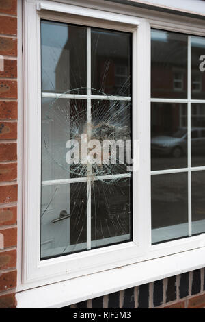 smashed broken double glazed window facing main road as a result of ...