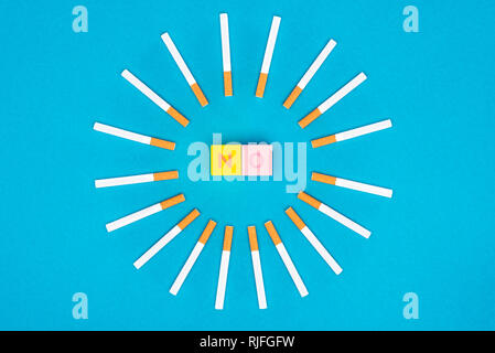 Studio shot of cigarettes and colorful cubes with letters isolated on ...