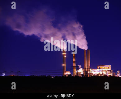 Smokestacks Billowing Smoke At Night Stock Photo - Alamy