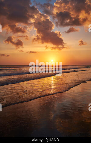 Sunset over beach in Seminyak, Bali, Indonesia Stock Photo - Alamy