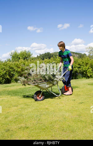 Boy pushing a wheelbarrow Stock Photo - Alamy