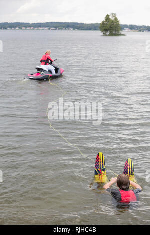 Jet ski pulling water skier Stock Photo - Alamy