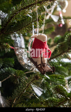 Christmas tree in a red cloak with a hood and an openwork masquerade ...